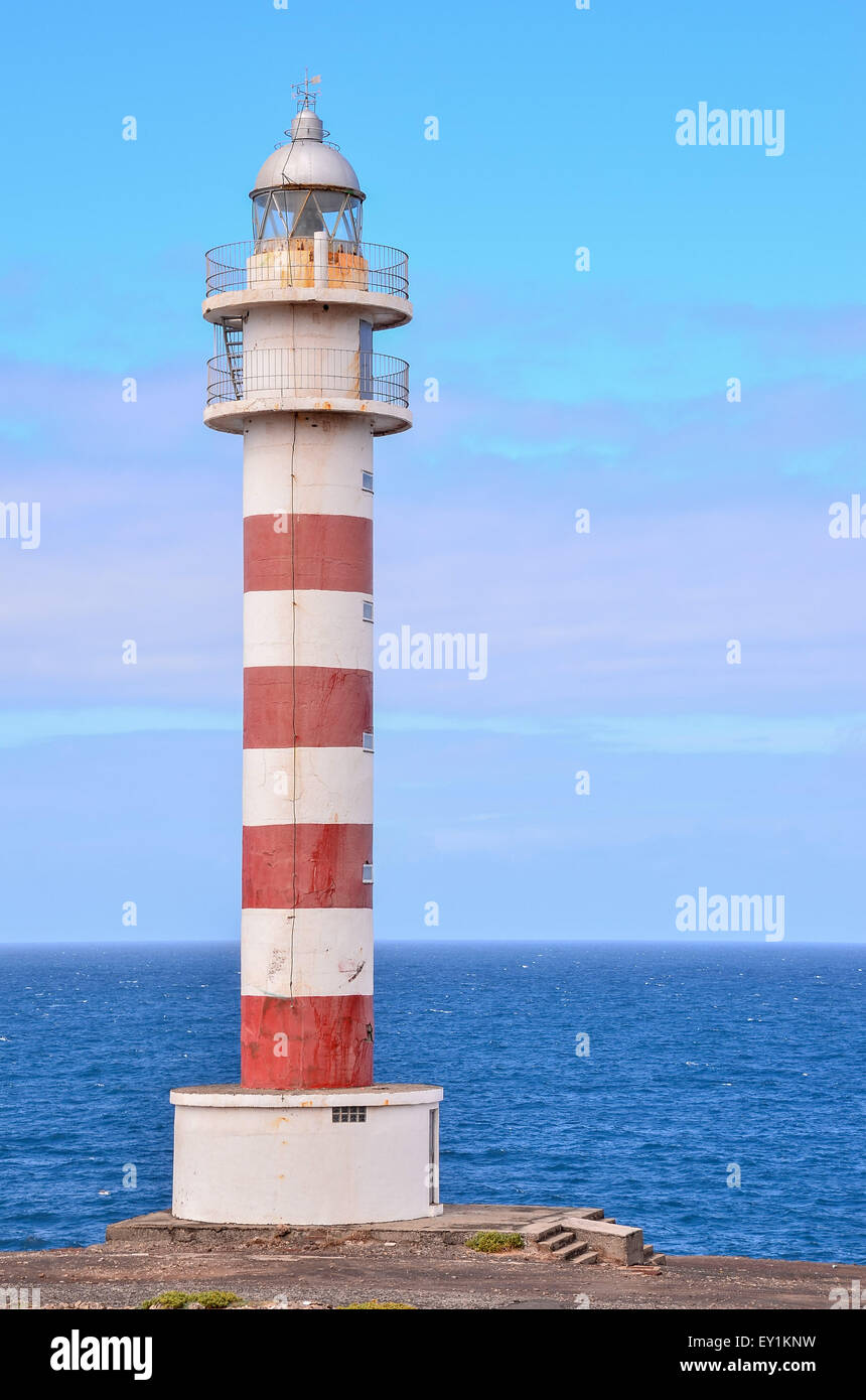 High Lighthouse near the Coast Stock Photo - Alamy