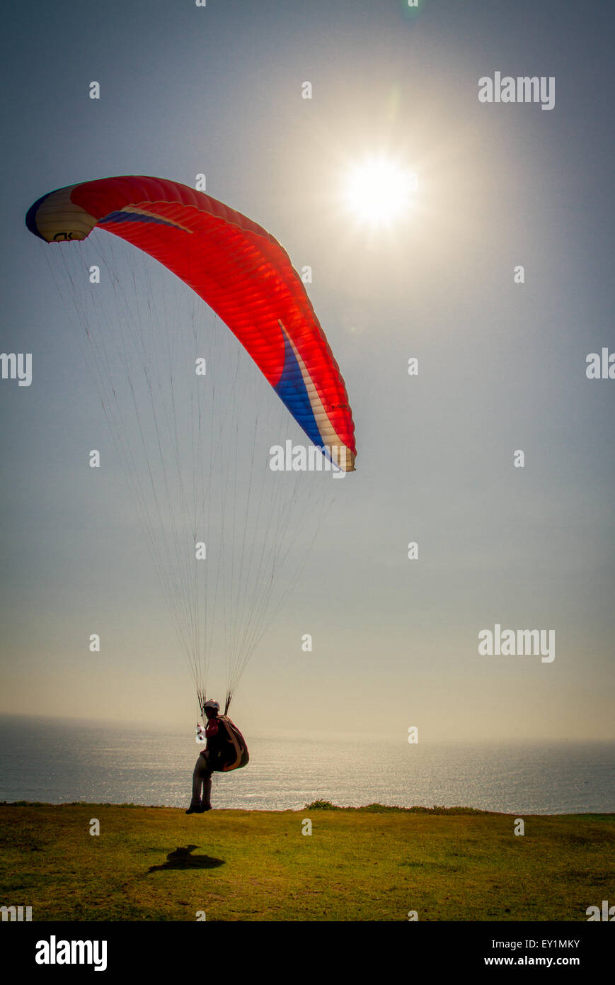 Paraglider taking off from a cliff Stock Photo - Alamy