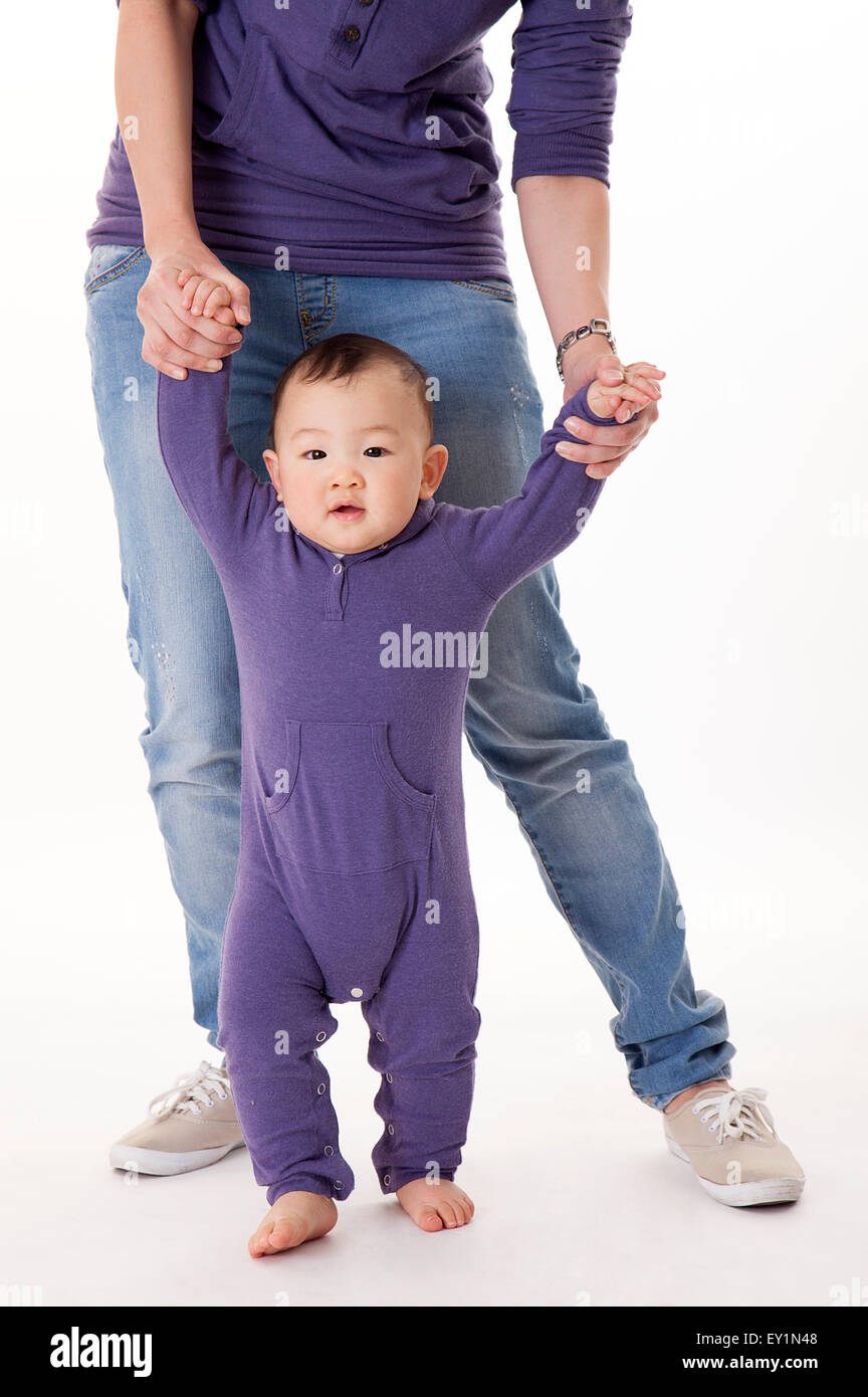 Baby boy standing and looking at the camera Stock Photo - Alamy