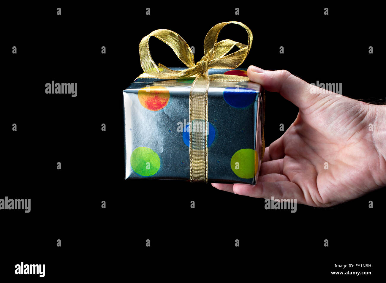 Hand Giving a Present Stock Photo - Alamy