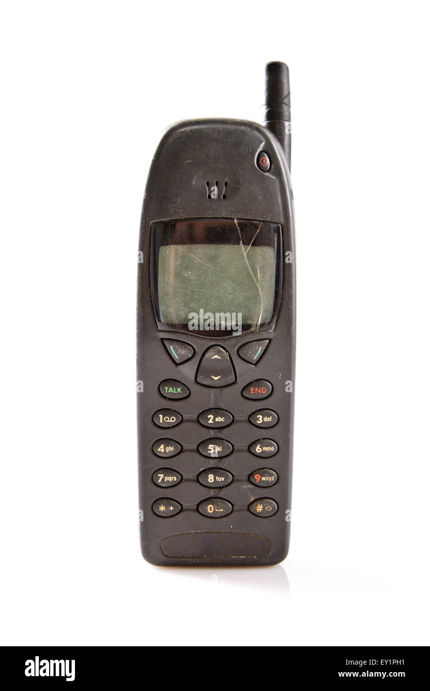 Old black cell phone isolated on the white background broken screen ...