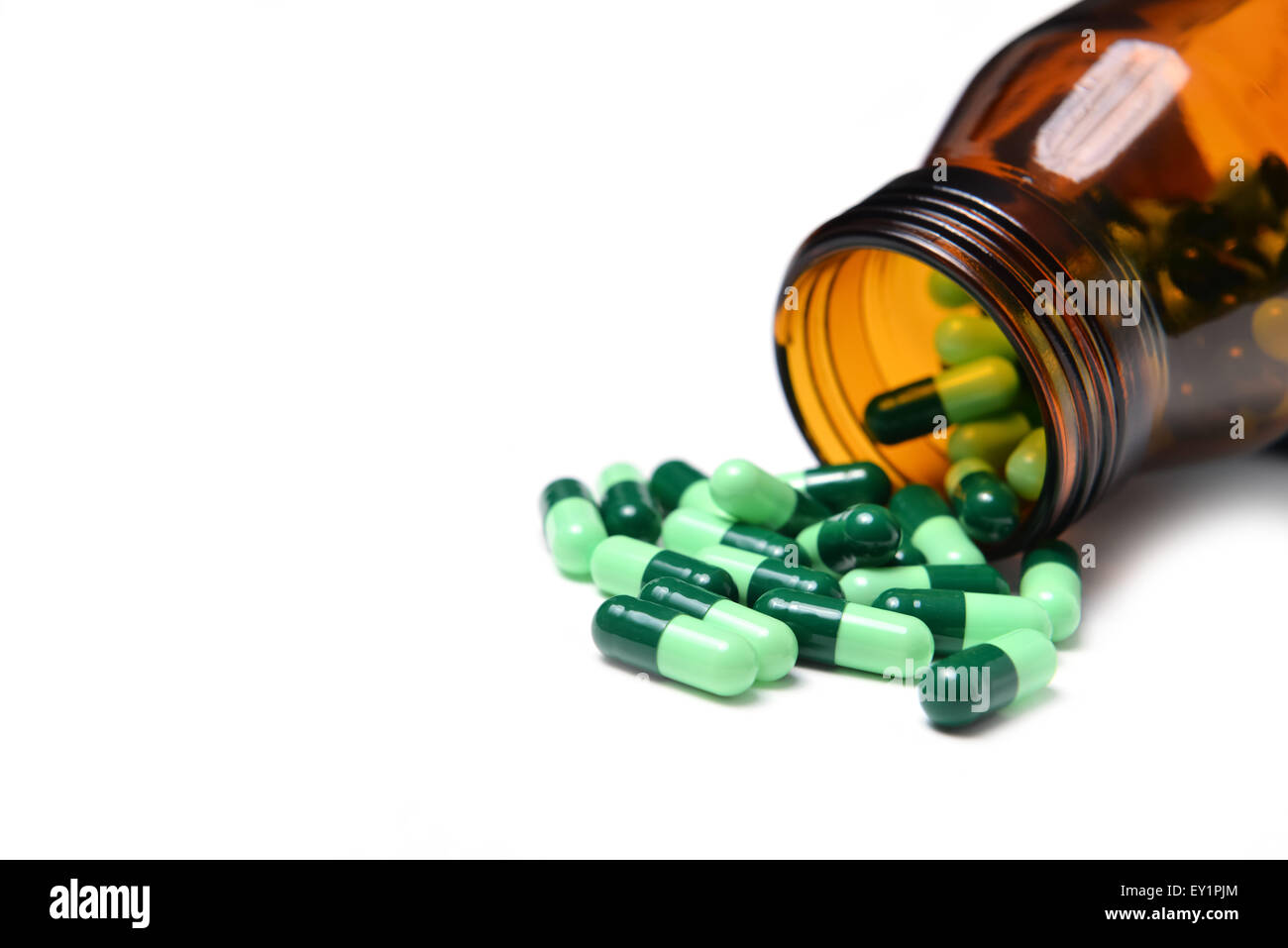 group of green capsule medicine in bottle on white background Stock ...