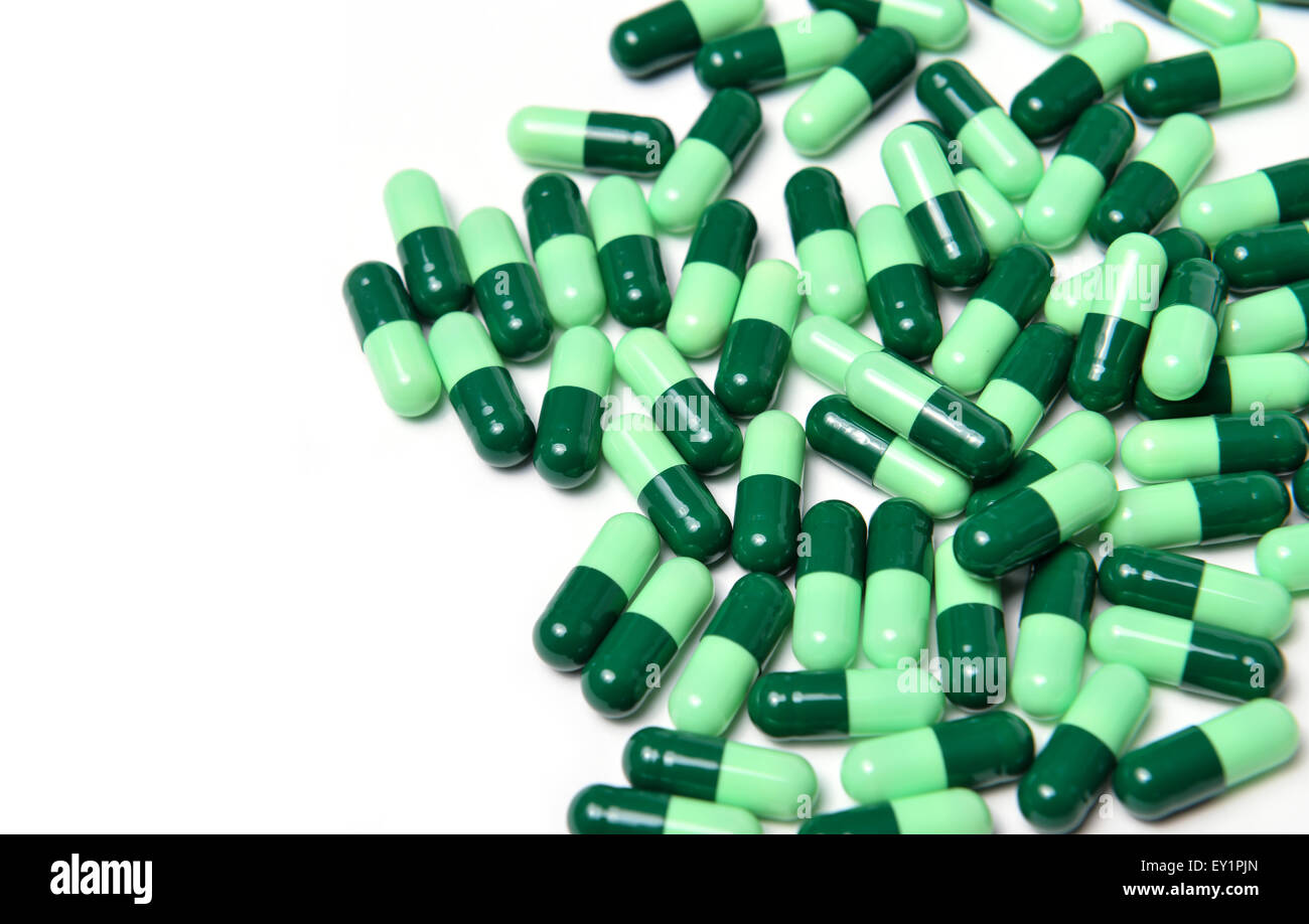 group of green capsule medicine on white background Stock Photo - Alamy