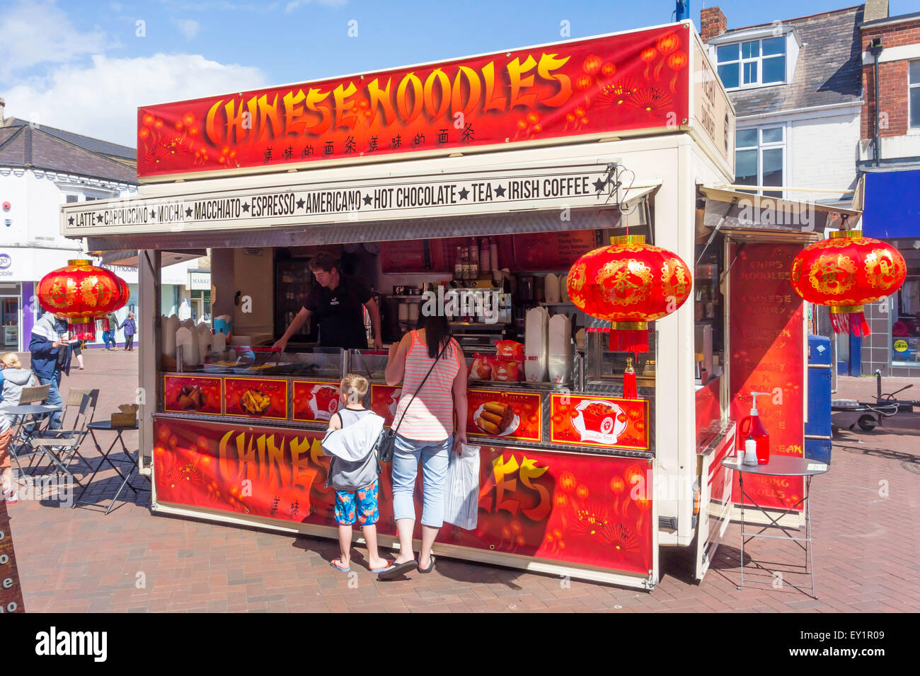 Woman and a boy at a Chinese Noodles Stall in the Market in Redcar ...