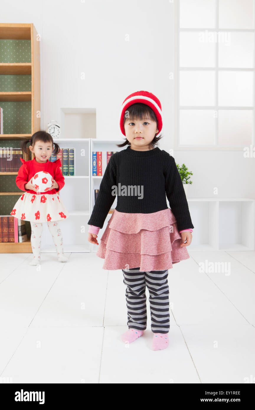 Little girl standing and looking at the camera Stock Photo - Alamy
