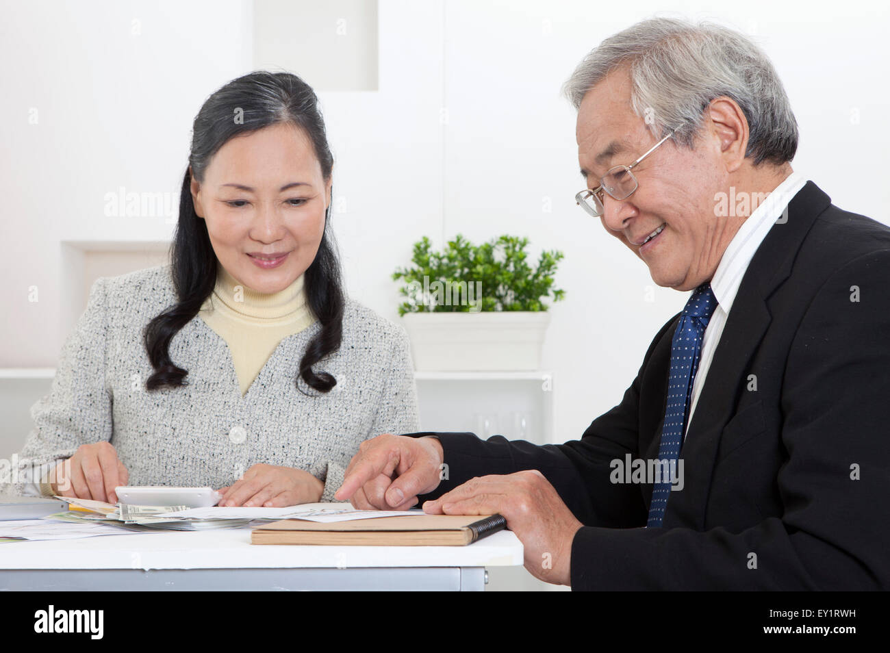 Senior couple discussing financial investment together Stock Photo - Alamy