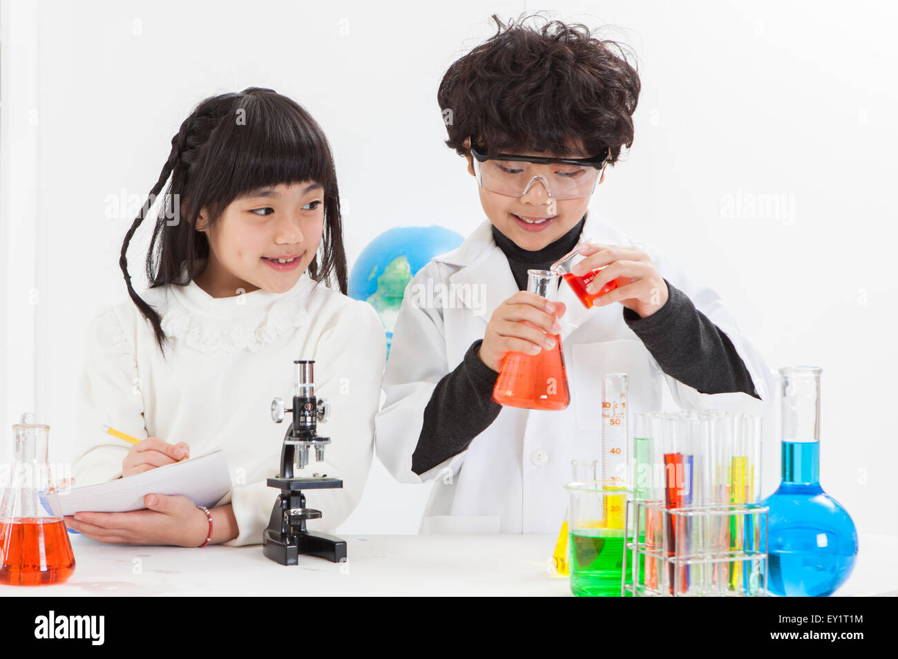 Children doing experiment in the lab with smile together Stock Photo ...