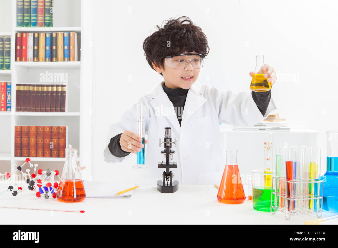 Boy doing experiment and looking away with smile Stock Photo - Alamy