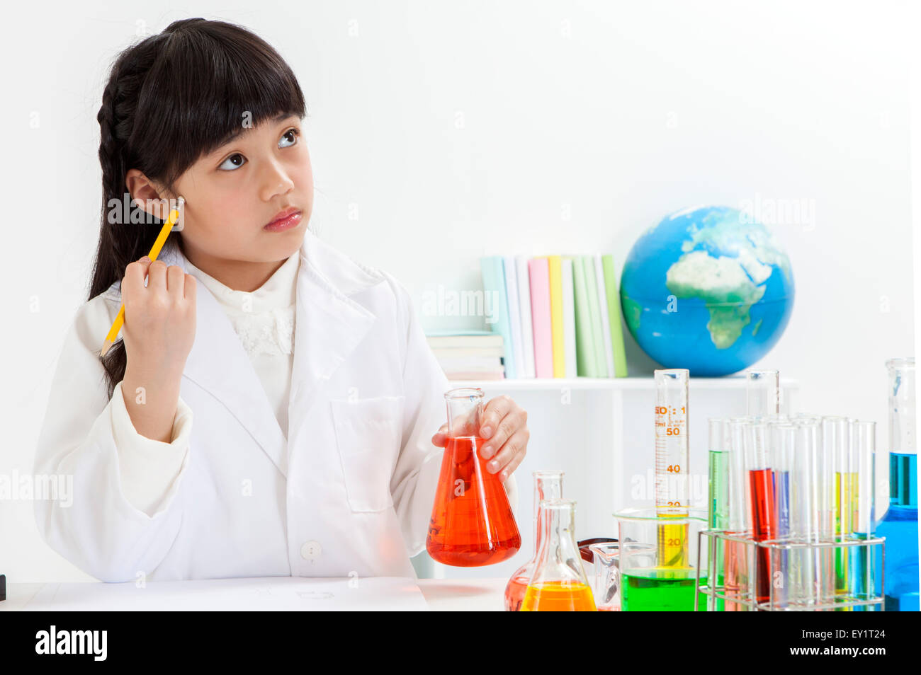 Girl doing experiment and looking up Stock Photo - Alamy