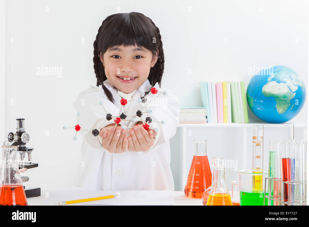 Girl holding models and smiling at the camera Stock Photo - Alamy