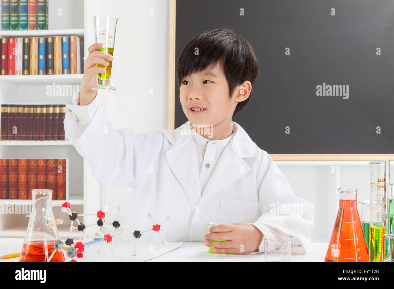 Boy doing experiment and looking away with smile Stock Photo - Alamy