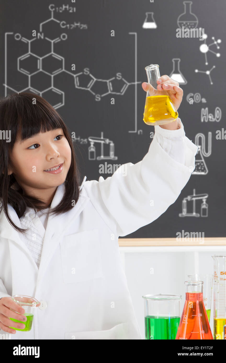 Girl doing experiment and looking away with smile Stock Photo - Alamy