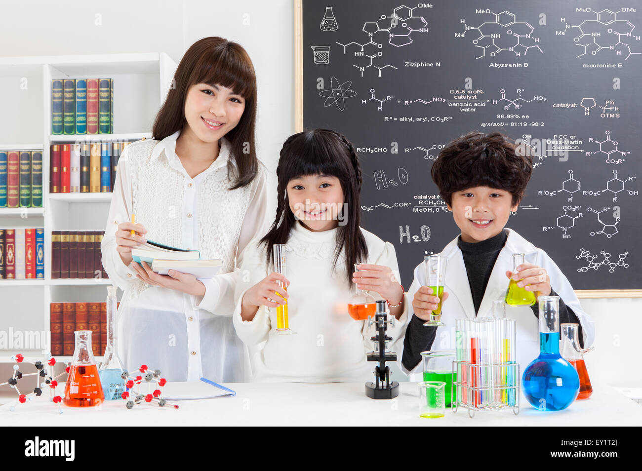 Children and teacher doing experiment in the lab with smile together ...