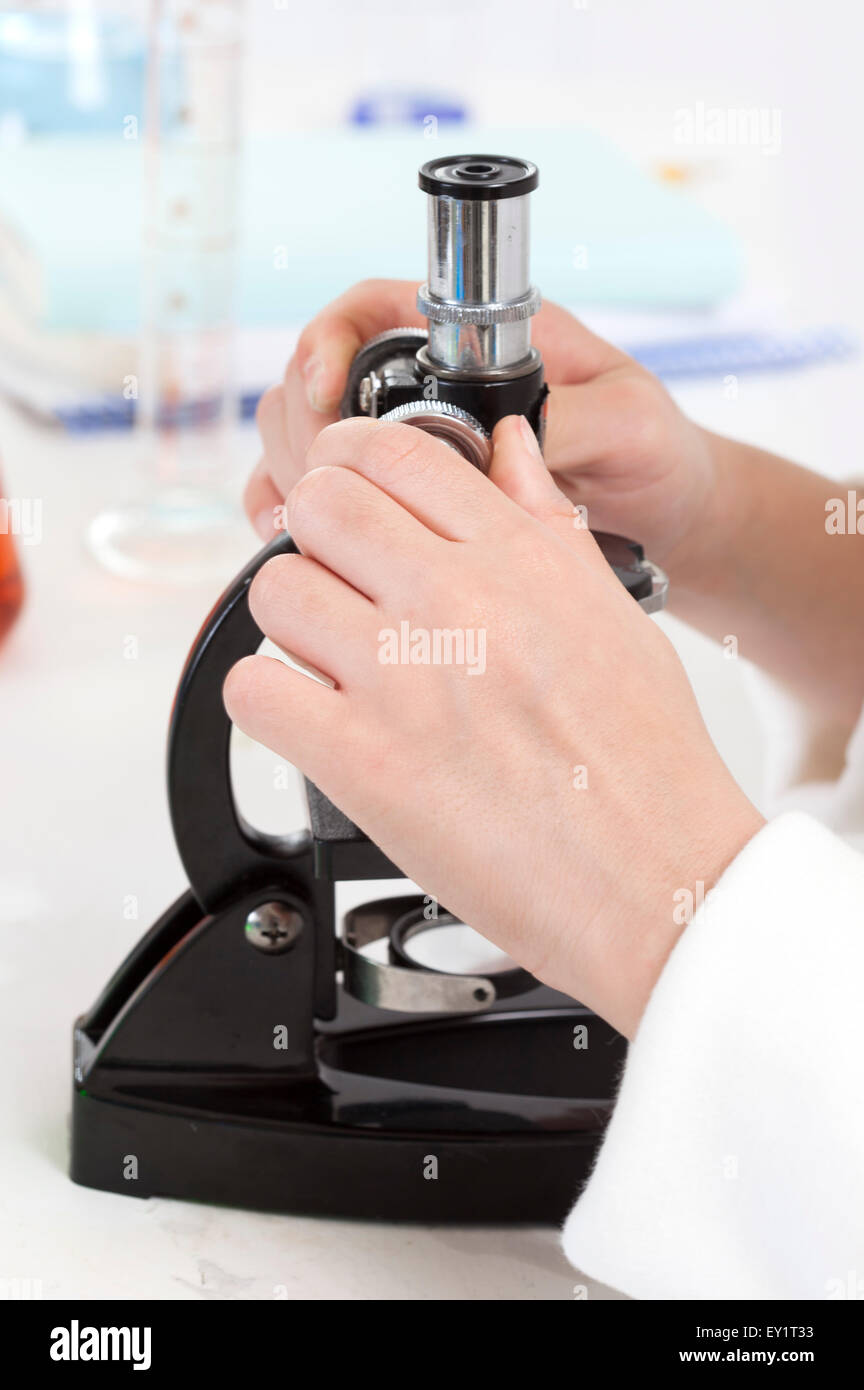 Close-up of human hands holding microscope Stock Photo - Alamy