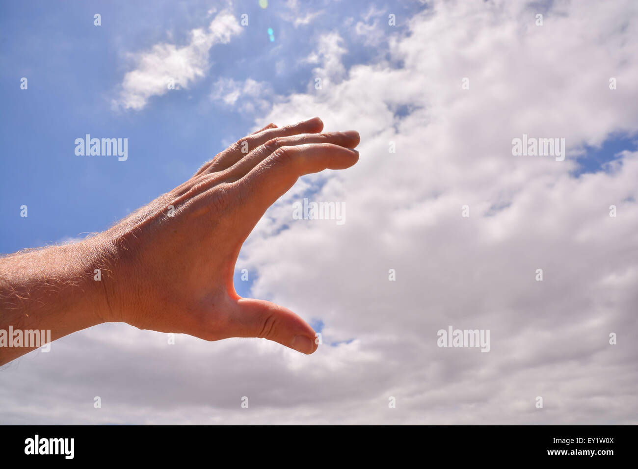 Hand over a Cloudy Sky Stock Photo - Alamy