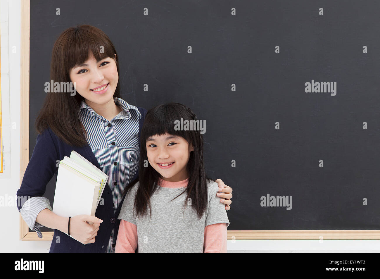 Young schoolgirl with teacher hi-res stock photography and images - Alamy