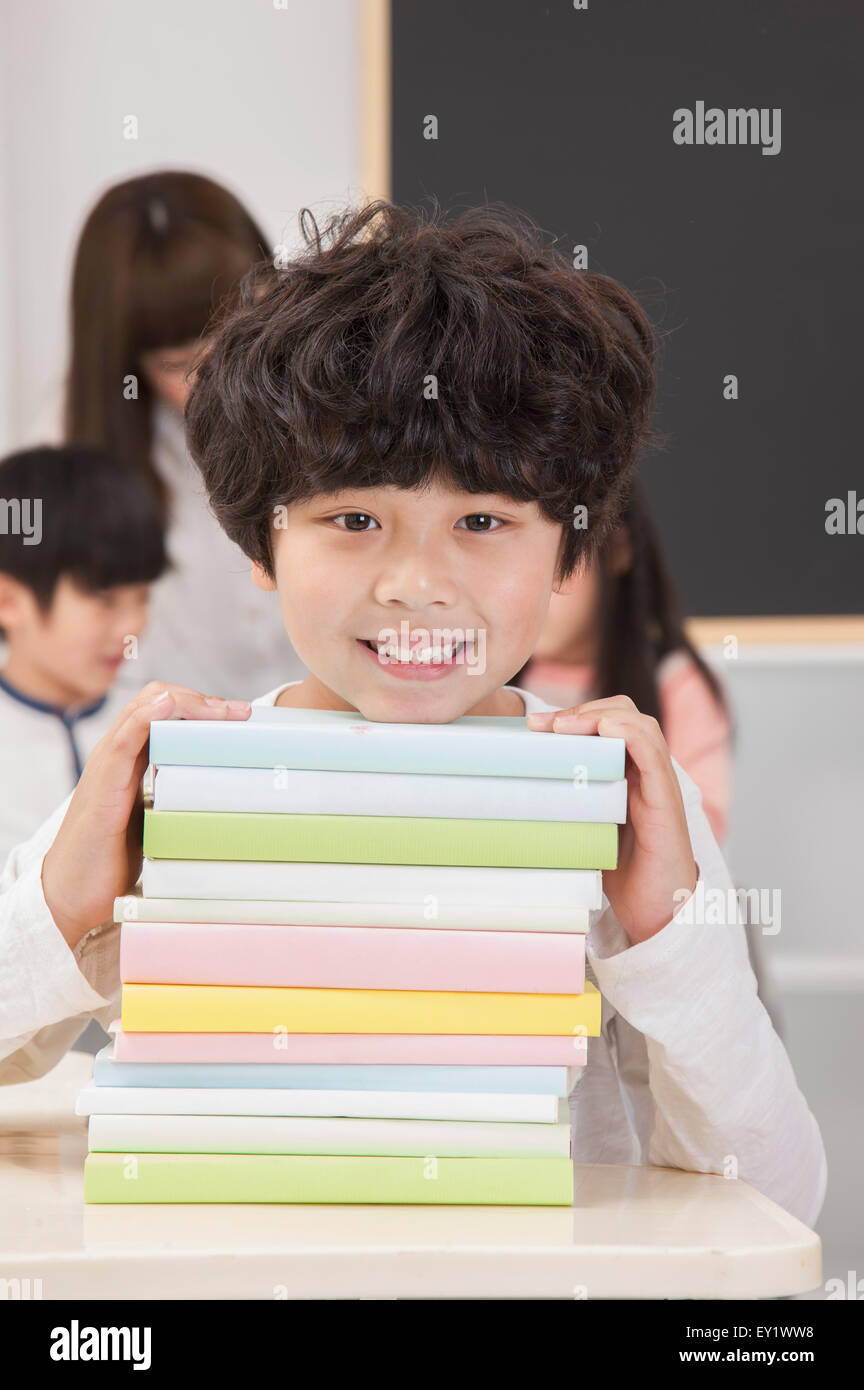 Boy holding books hi-res stock photography and images - Alamy