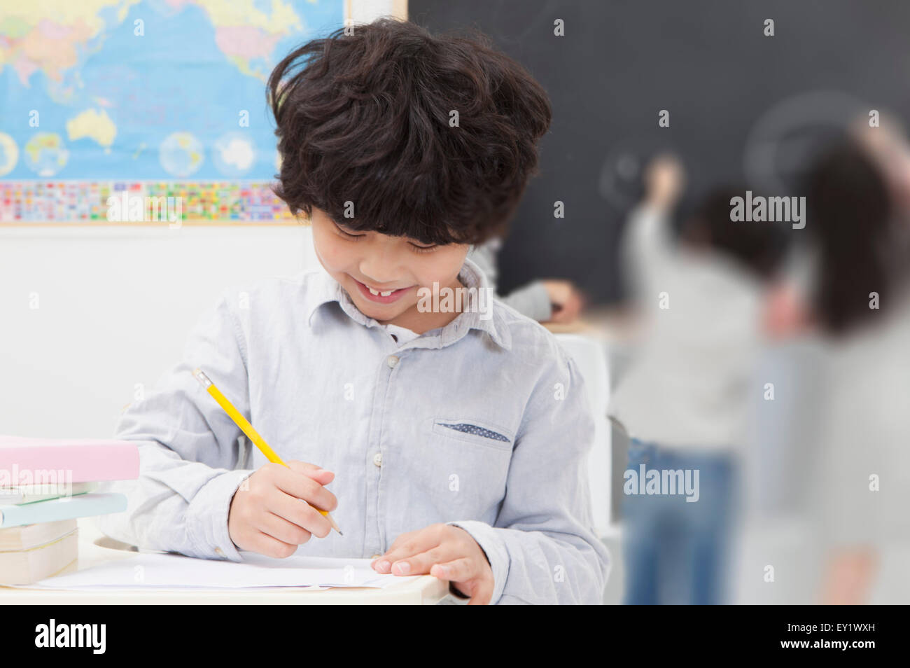 Children studying in the classroom and looking down with smile Stock ...