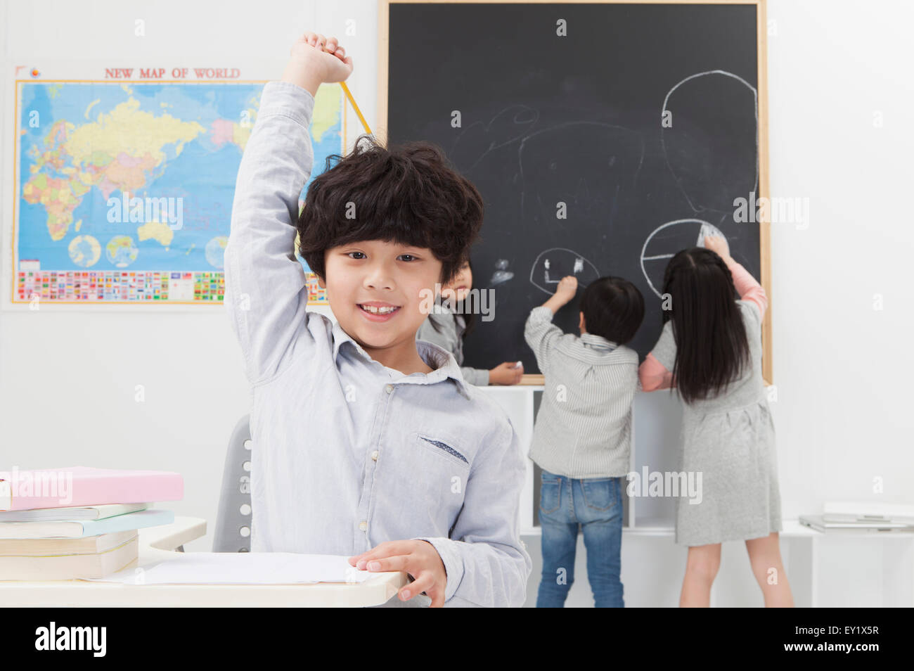 Boy studying in the classroom and smiling at the camera Stock Photo - Alamy
