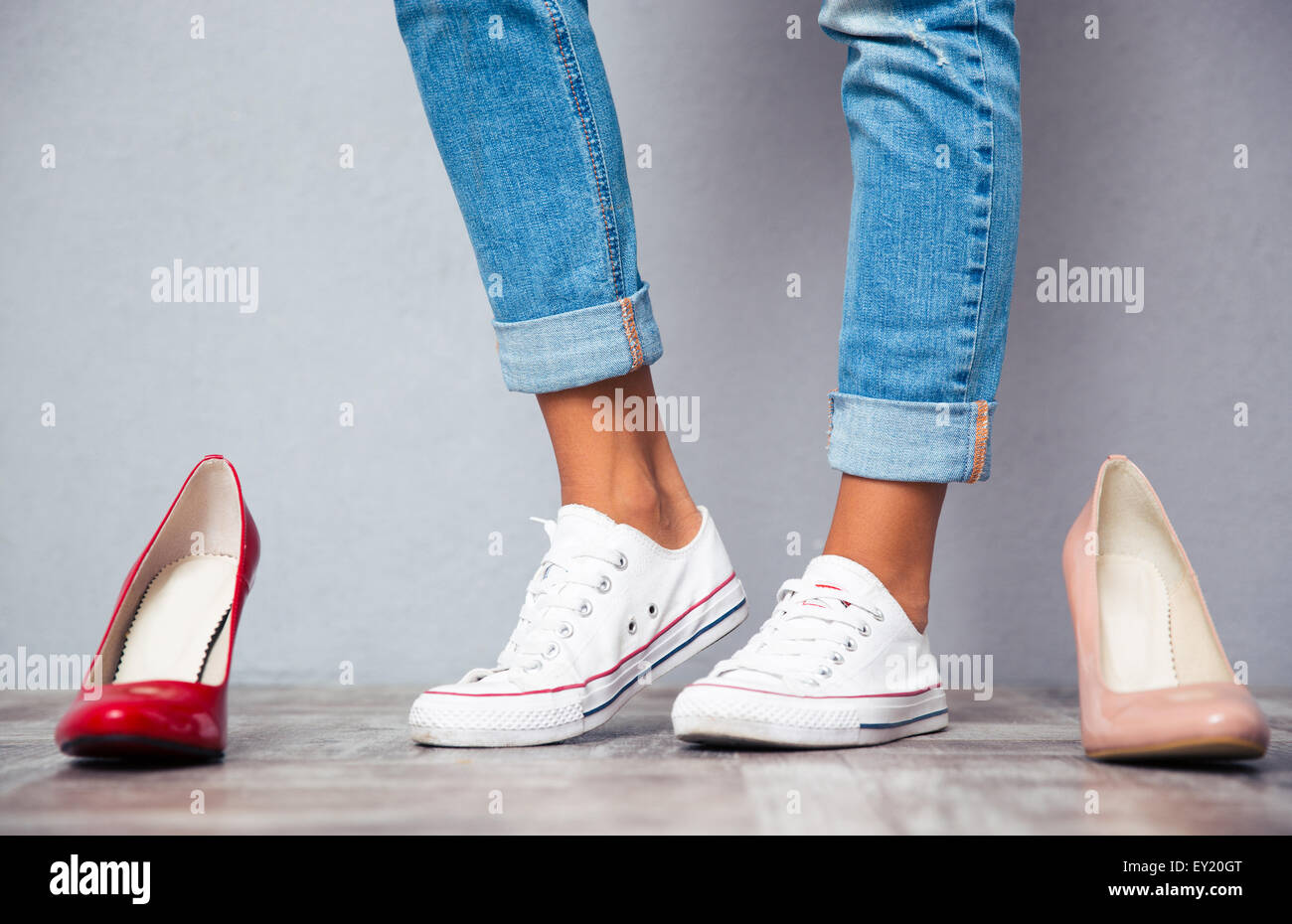 Closeup portrait of female legs with shoes on gray background Stock ...
