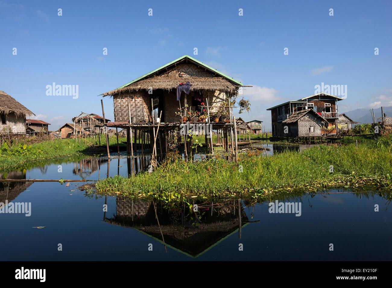 Traditional stilt houses in Inle Lake, reflection in the water, Shan ...