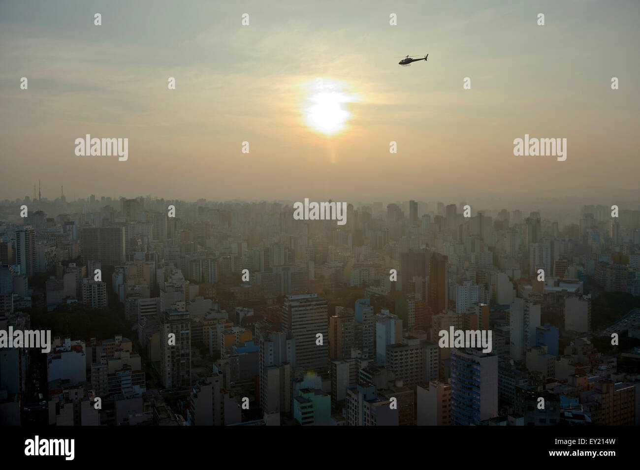 Helicopter above a cityscape with skyscrapers at sunset, São Paulo ...