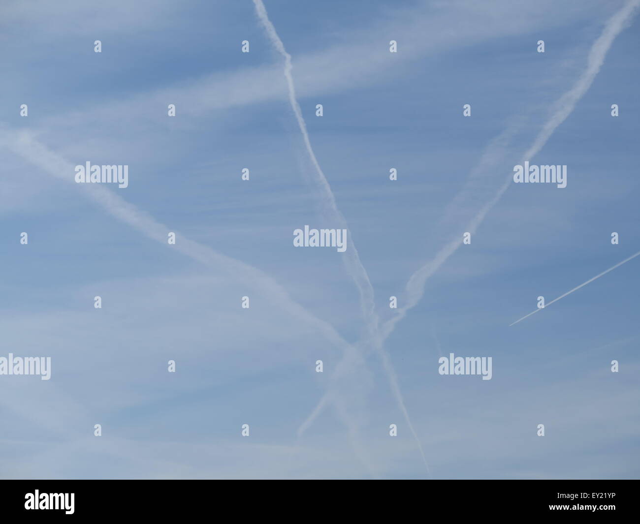 Jet contrails in a blue sky Stock Photo - Alamy