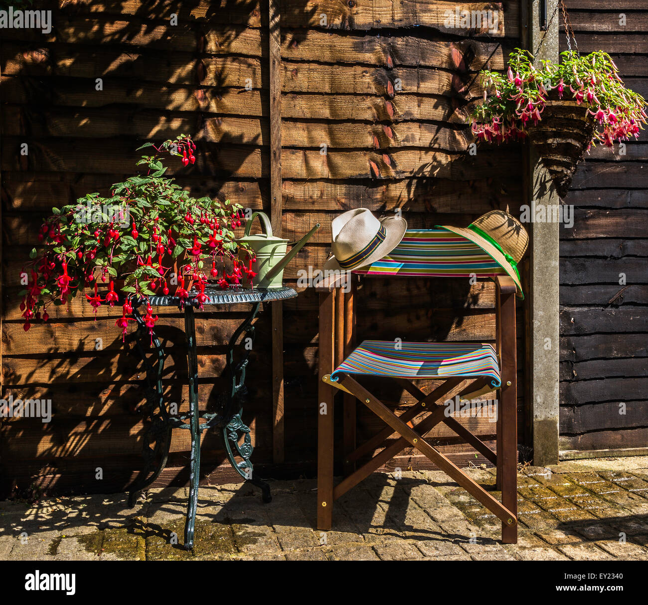 Straw Hats on Colourful Garden Chair Stock Photo - Alamy