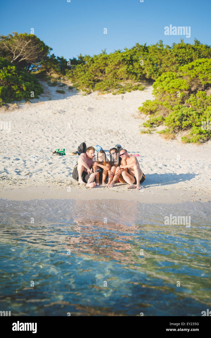 Group of young multiethnic friends with digital tablet sitting at the ...