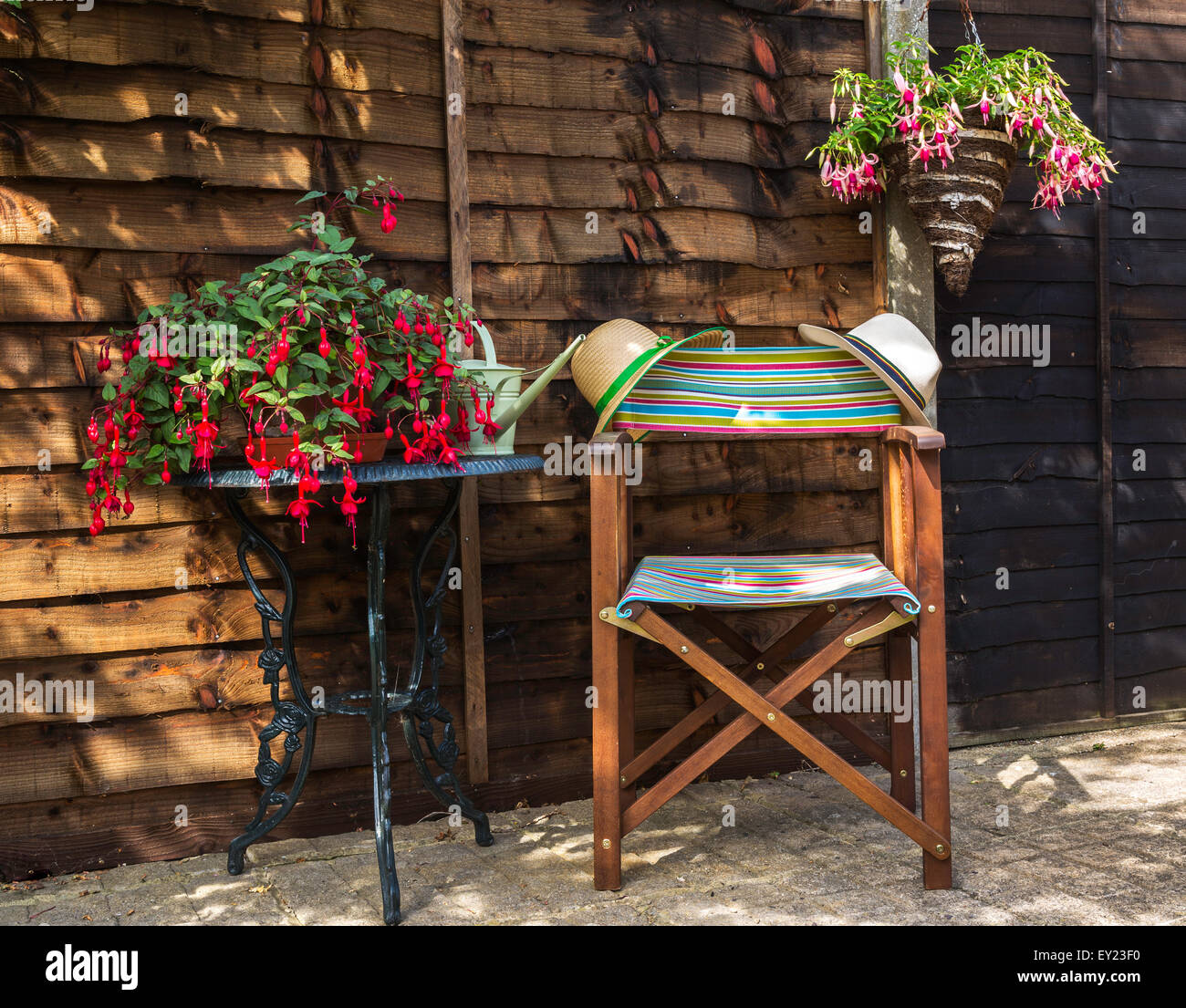 Pair of Straw Hats on Colourful Garden Chair Stock Photo - Alamy