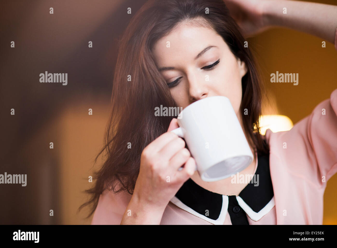 Young woman drinking coffee Stock Photo - Alamy