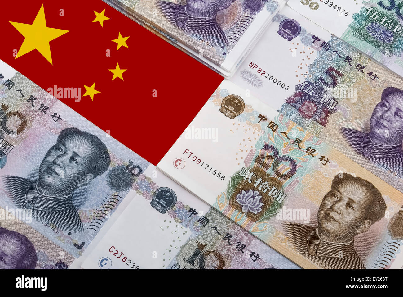 Chinese banknotes lined up with a Chinese flag in the top left corner ...