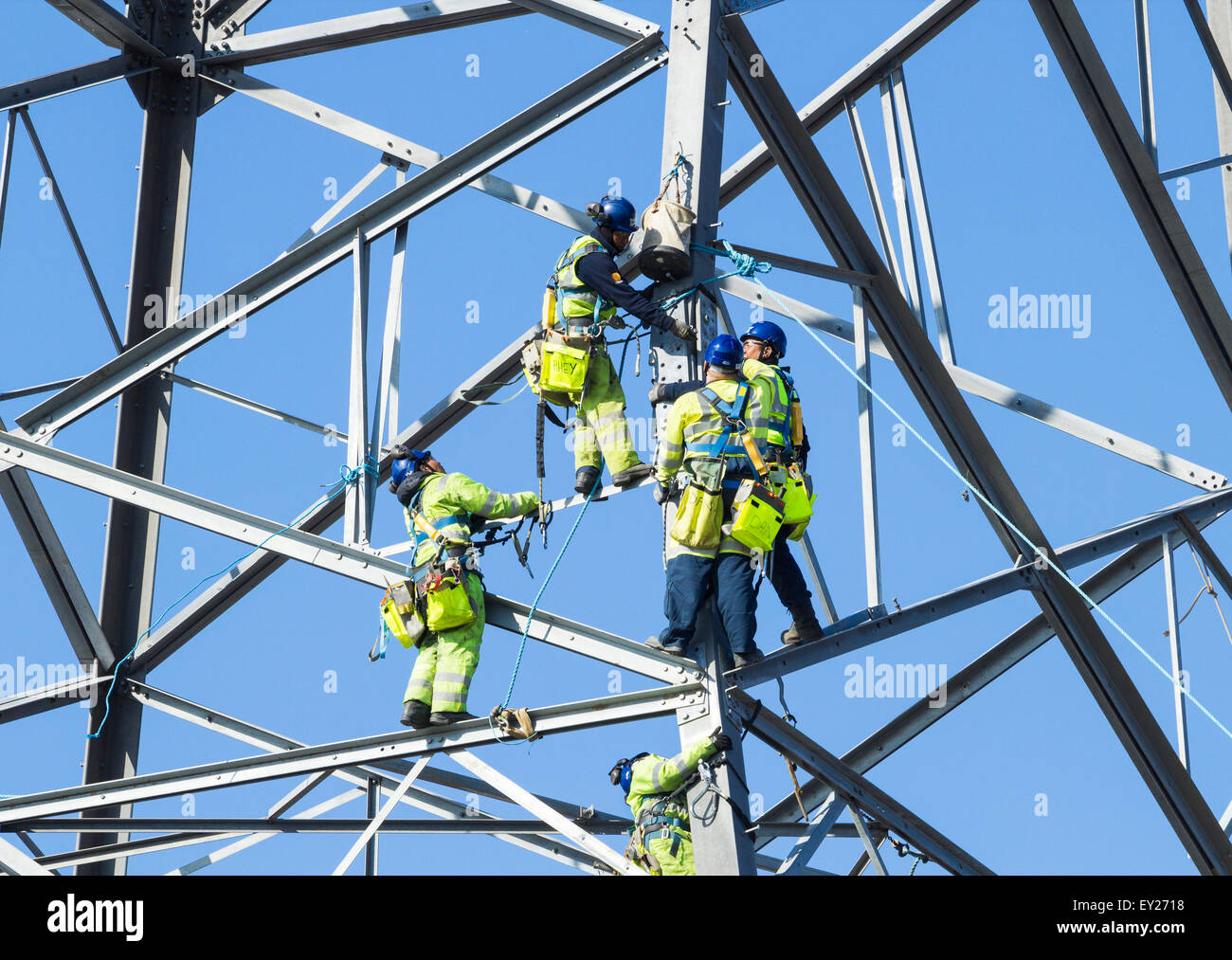 Workers erecting 145 metre tall electricity pylons across the river ...