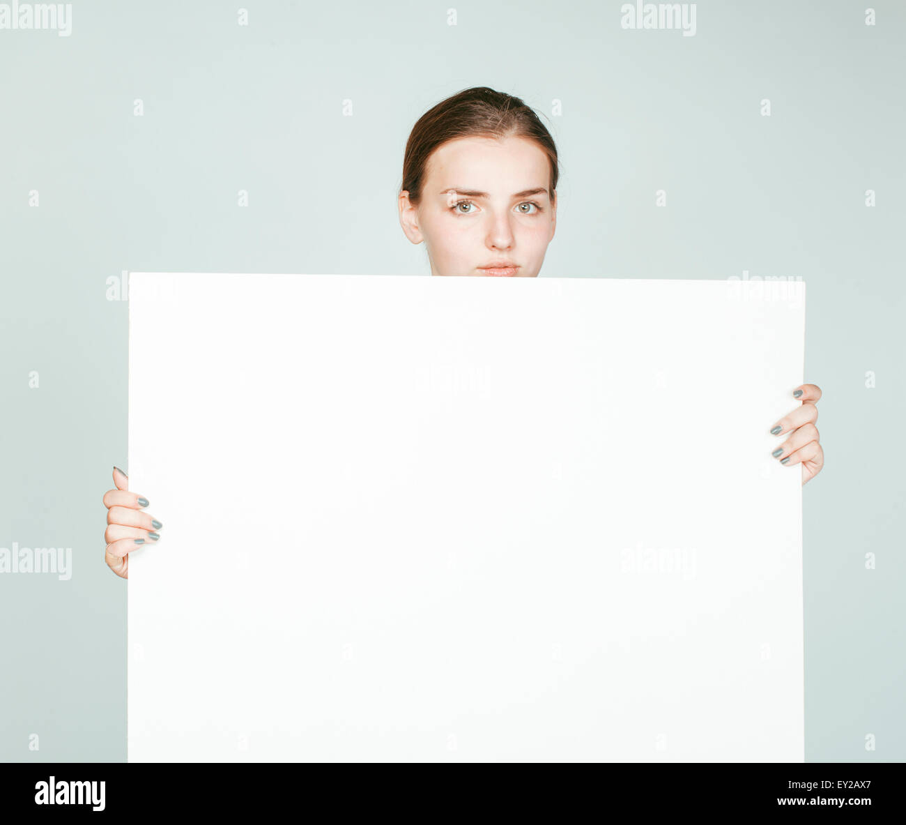 young pretty brunette girl with placard on white background Stock Photo ...