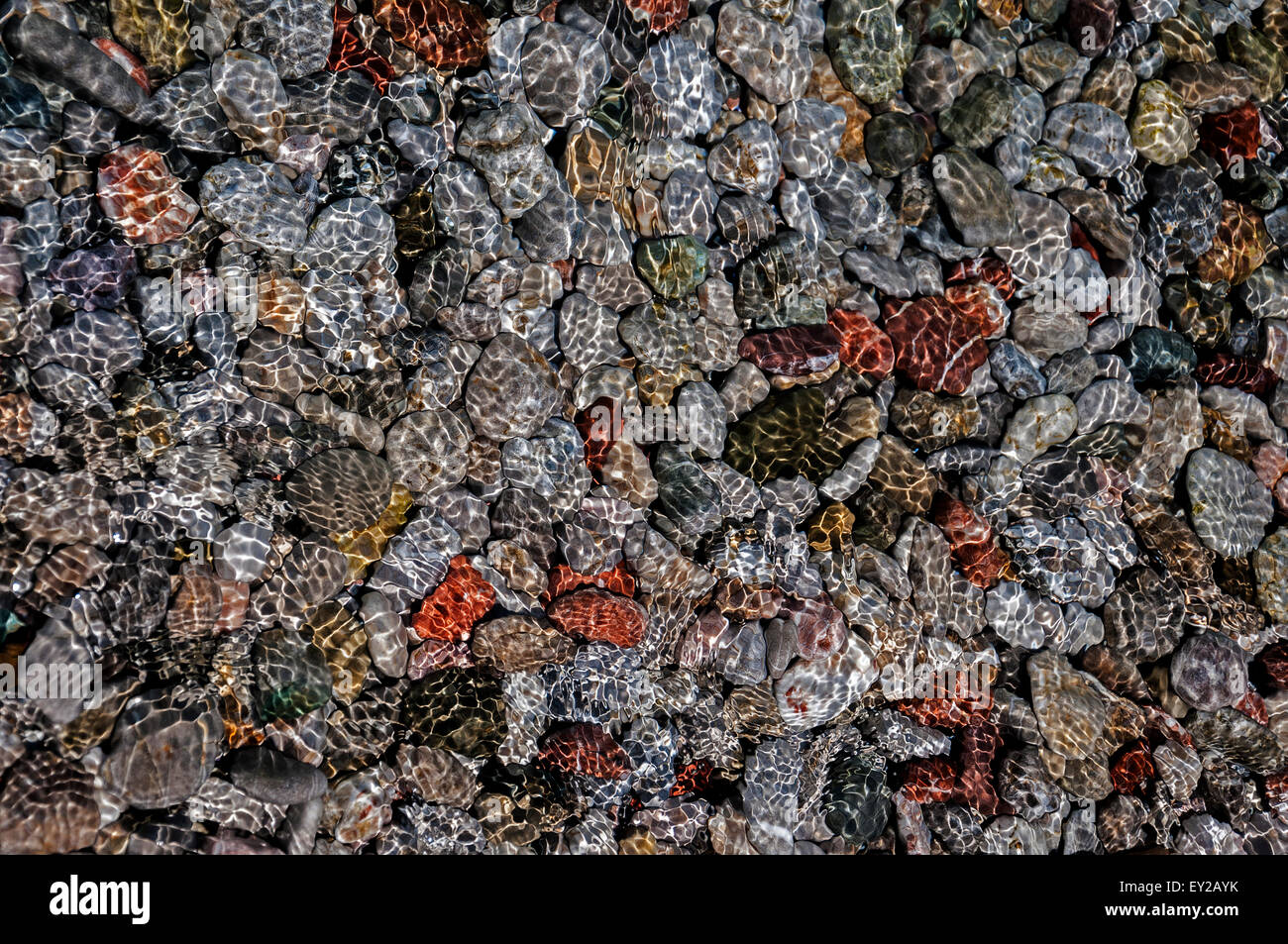 Coloured pebbles under shallow sea water Stock Photo - Alamy
