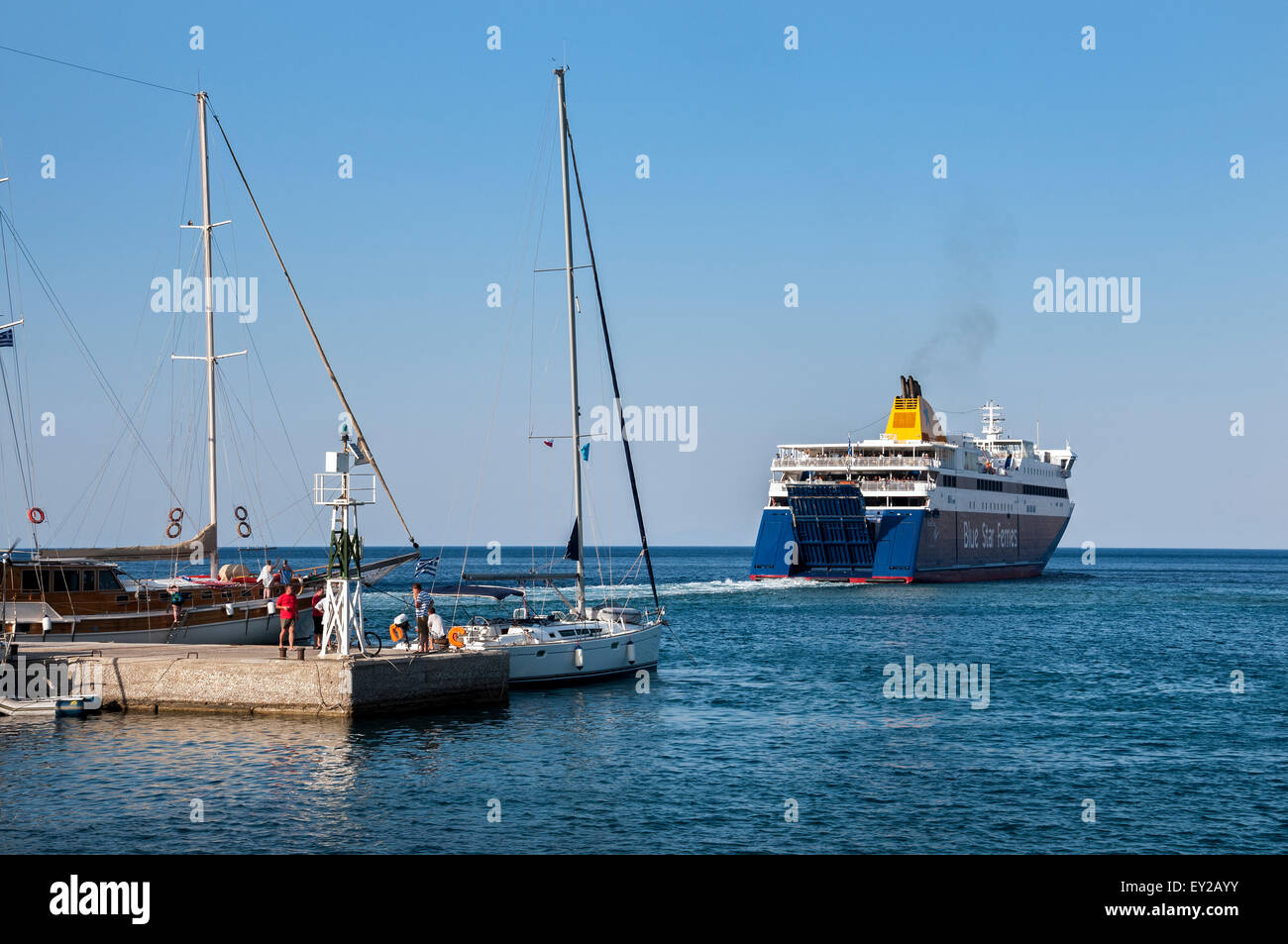 Ferry leaving Tilos harbour Stock Photo - Alamy