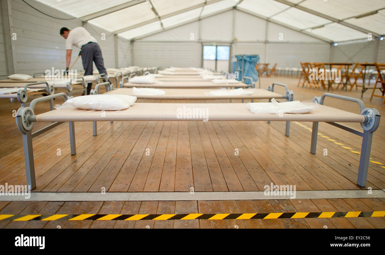 A volunteer of the German Red Cross sweeps the floor of a refugee ...