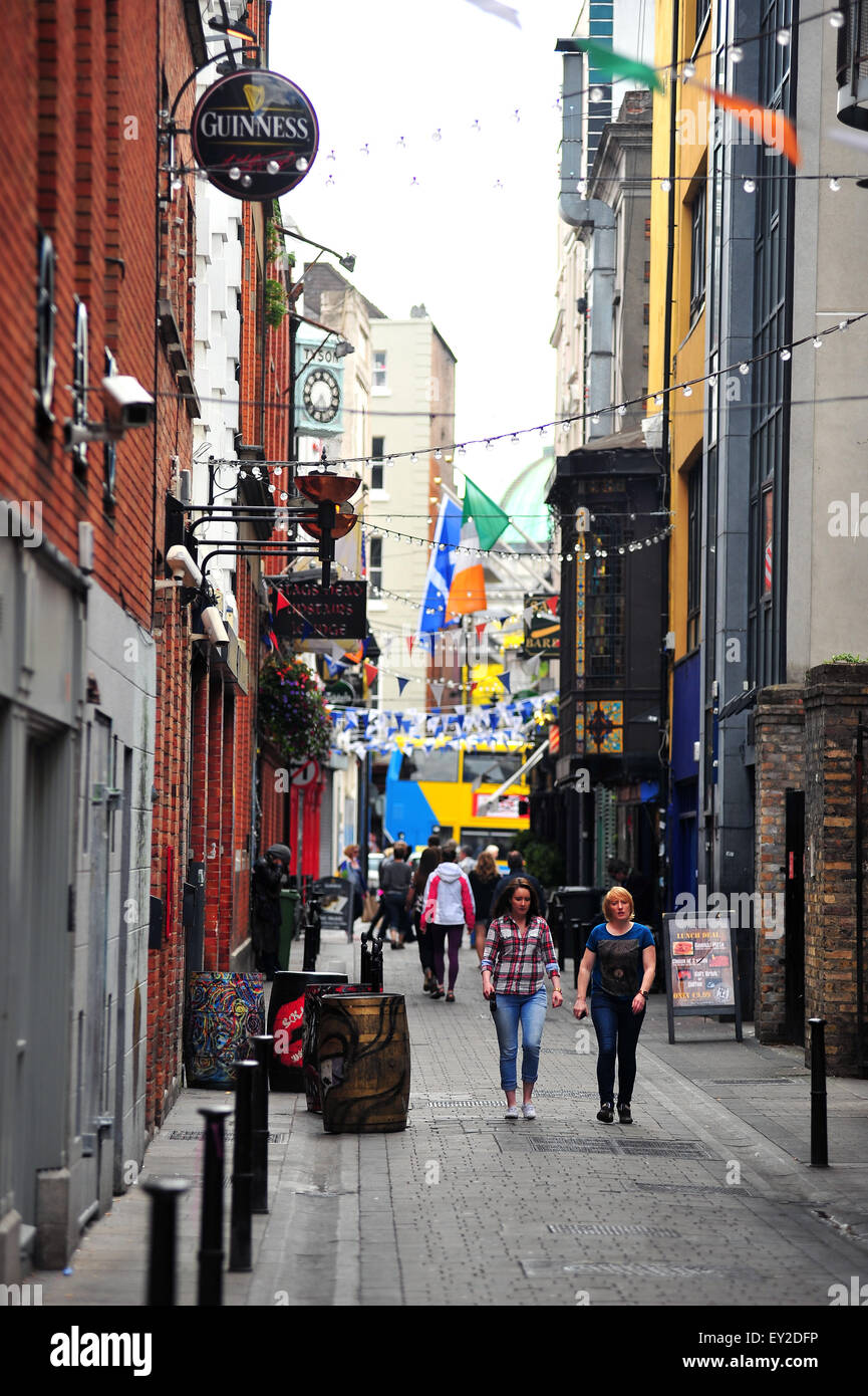 Pedestrians walk down a narrow street in the centre of Dublin in ...