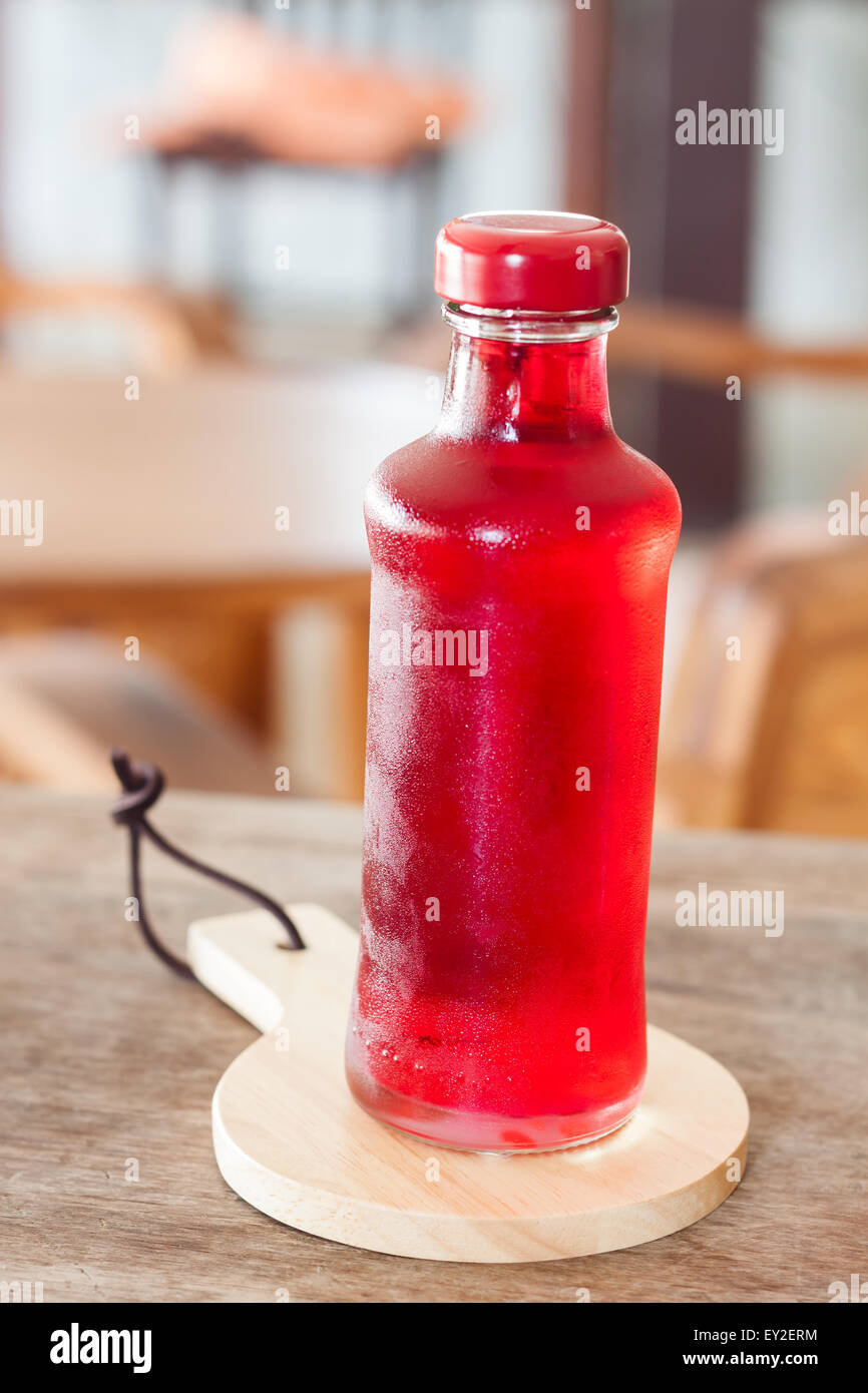 Red syrup in the bottle on wooden plate, stock photo Stock Photo - Alamy