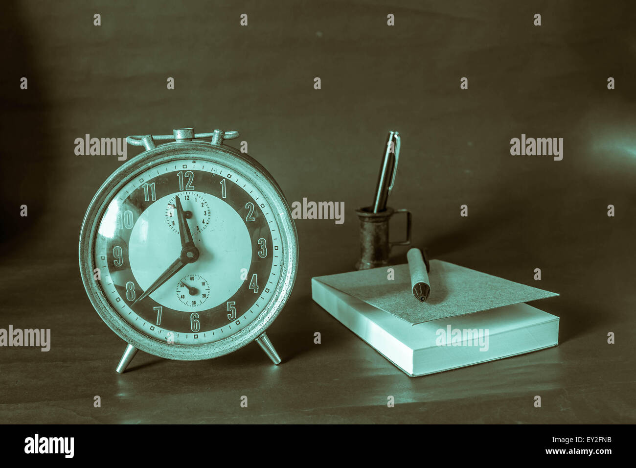 Clock and writing on a black background Stock Photo - Alamy