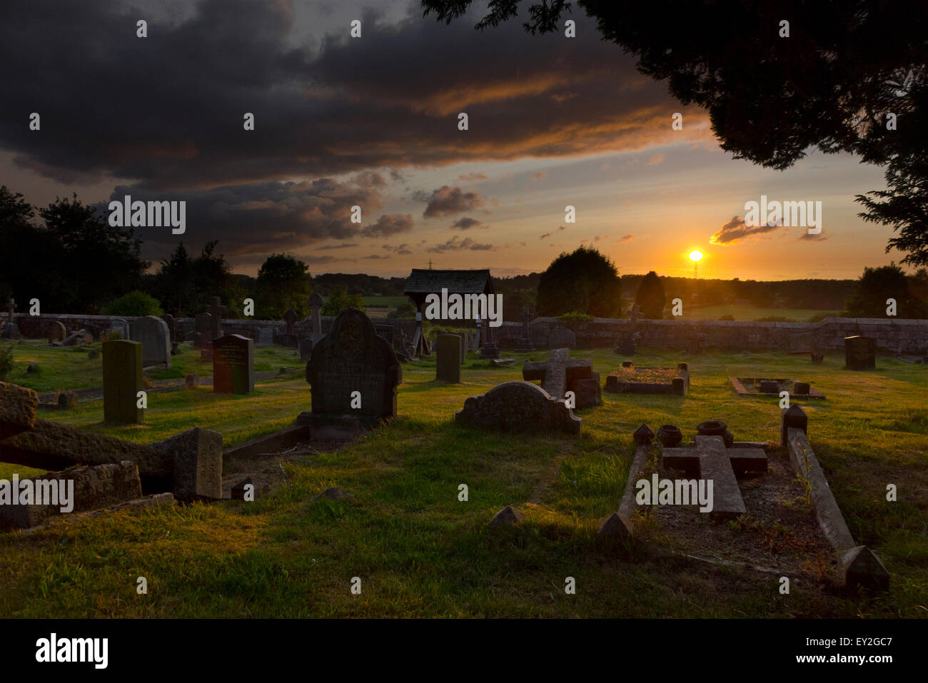 sunset over graveyard church yard Stock Photo - Alamy