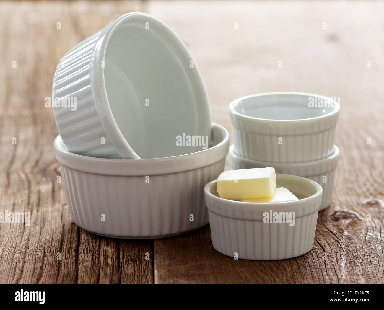 Group of white ramekins, on barn wood Stock Photo - Alamy