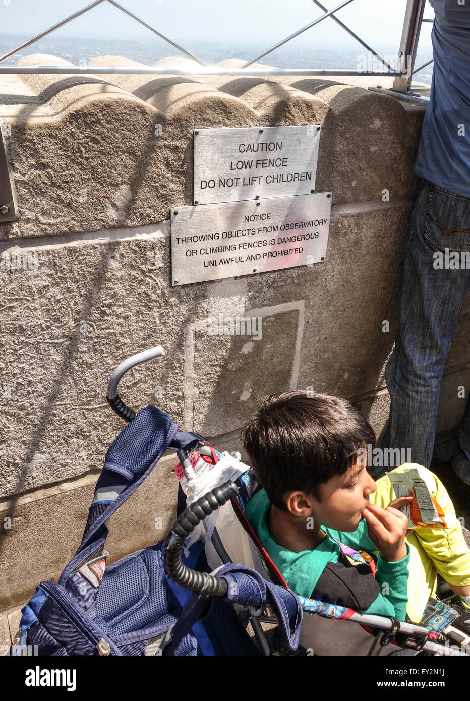 Boy in stroller, Sign to protect children and throwing objects ...