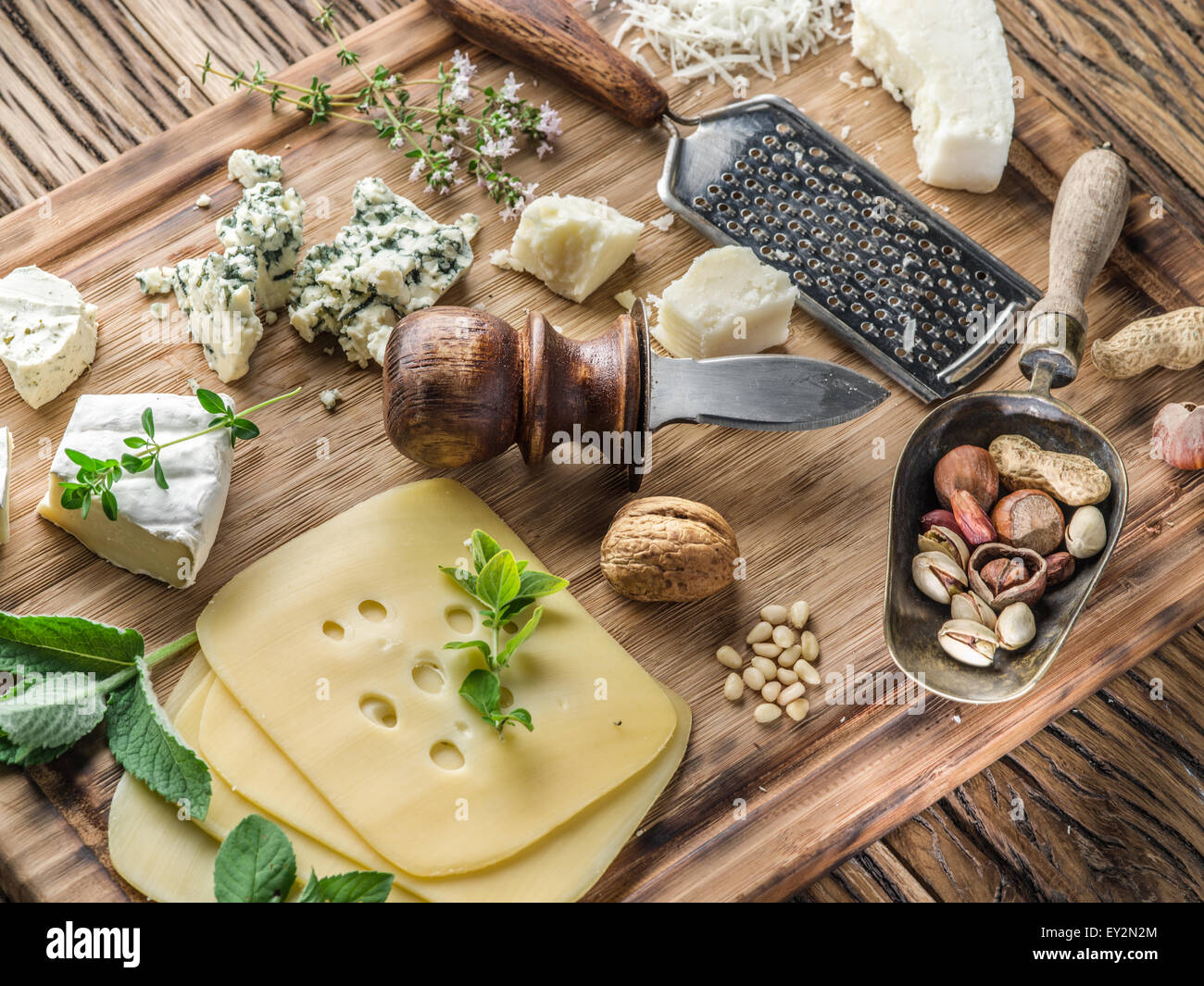 Different types of cheeses with nuts and herbs. Top view Stock Photo ...