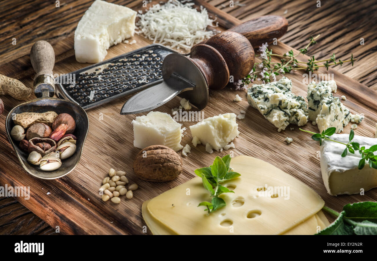 Different types of cheeses with nuts and herbs. Top view Stock Photo ...