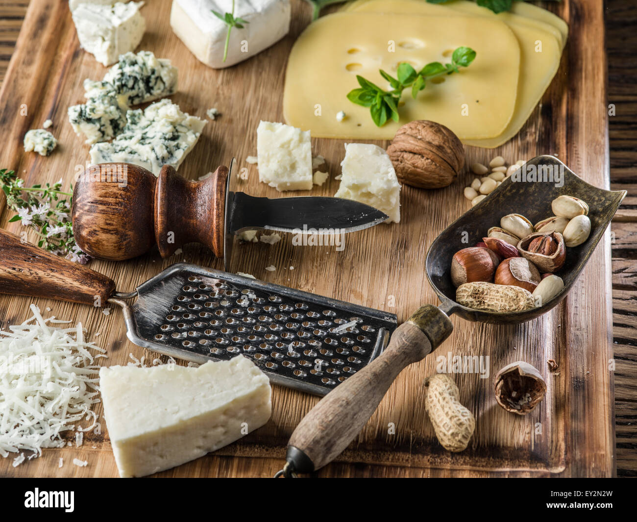 Different types of cheeses with nuts and herbs. Top view Stock Photo ...