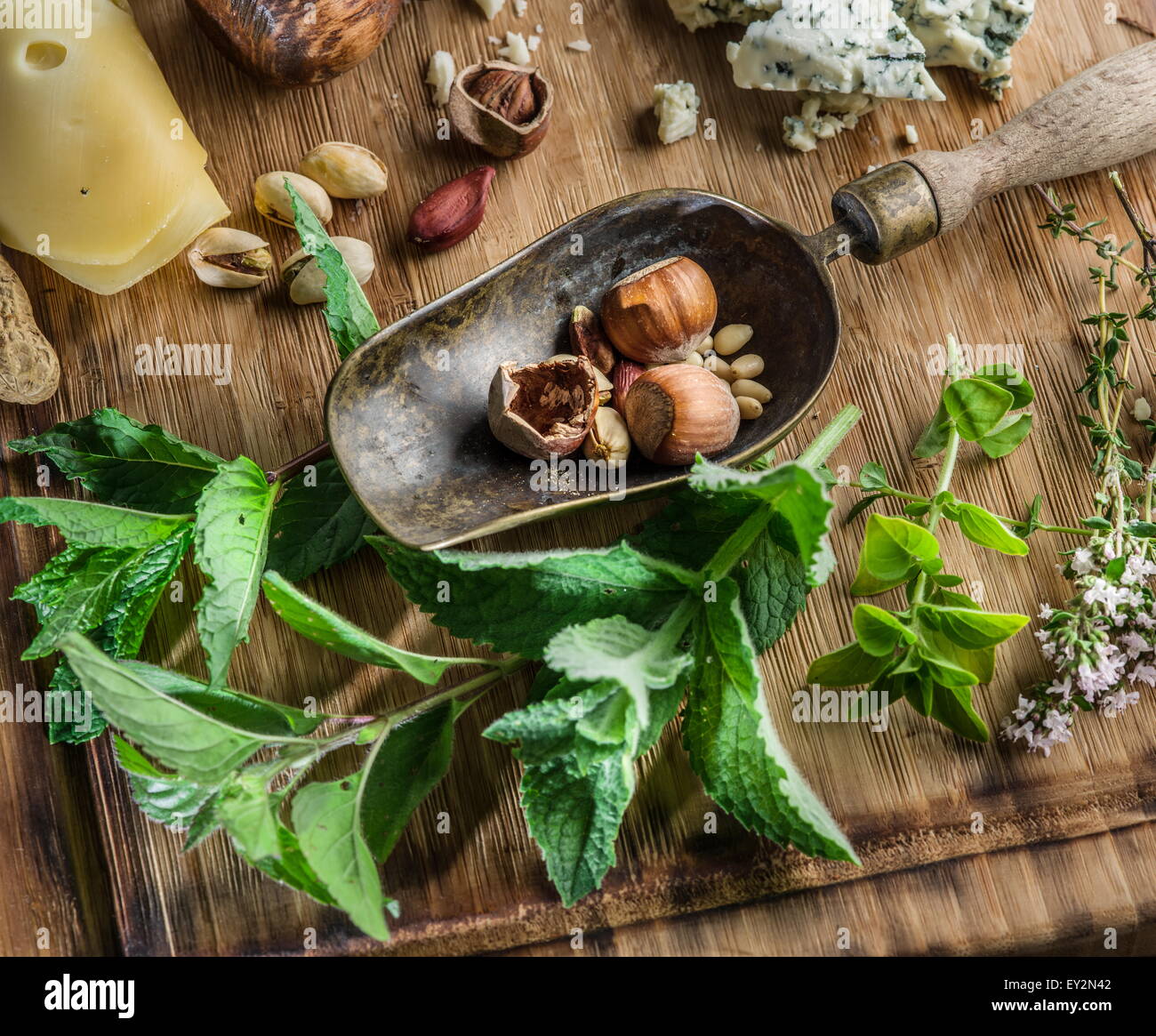 Different types of cheeses with nuts and herbs. Top view Stock Photo ...