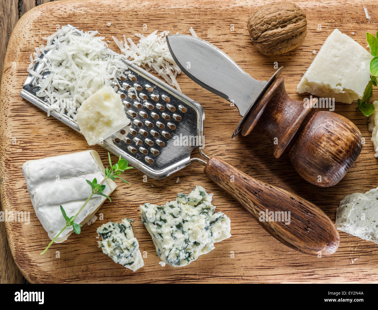 Different types of cheeses with nuts and herbs. Top view Stock Photo ...