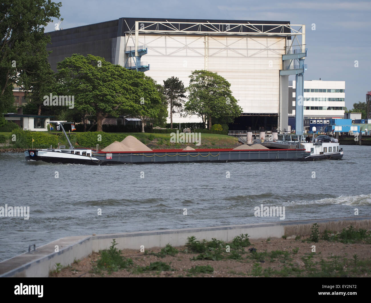 Ambitie, a container ship and oil tanker, operates on the Noord River ...