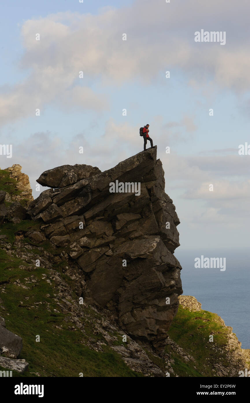 A daring walker stands on the Lovers Stone, where young men used to ...